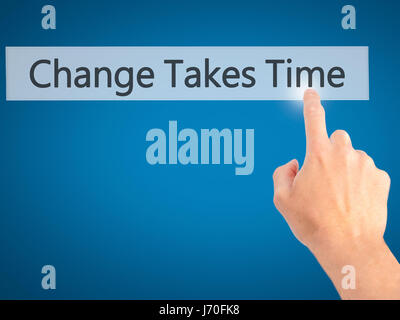 Change Takes Time - Hand pressing a button on blurred background ...