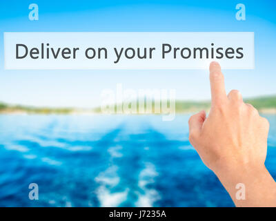 Deliver on your Promises - Hand pressing a button on blurred background ...