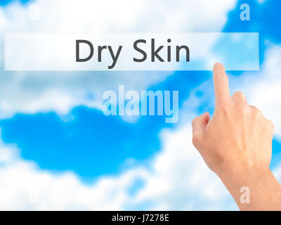 Dry Skin - Hand pressing a button on blurred background concept ...