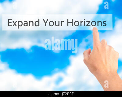 Expand Your Horizons - Hand pressing a button on blurred background ...