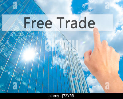 Free Trade - Hand pressing a button on blurred background concept ...