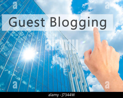 Guest Blogging - Hand pressing a button on blurred background concept ...