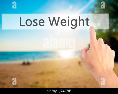 How To Lose Weight - Hand pressing a button on blurred background ...