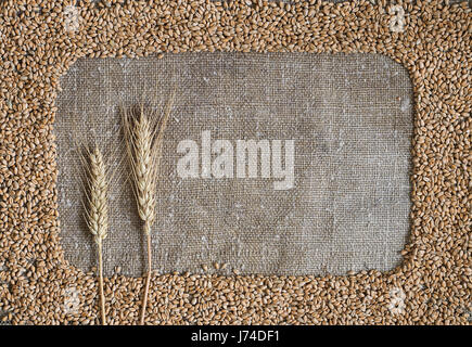 Ears of wheat in the form frame on old wooden table Stock Photo - Alamy