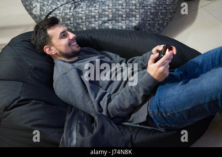 Bearded man sitting on gaming chair preparing to play online video ...