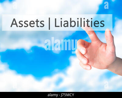 Assets Liabilities - Hand pressing a button on blurred background ...