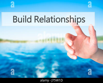Build Relationships - Hand pressing a button on blurred background ...