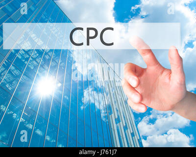 CPC - Hand pressing a button on blurred background concept . Business ...