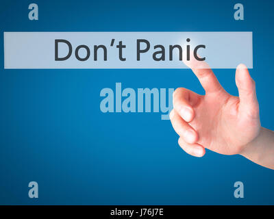 Don't Panic - Hand pressing a button on blurred background concept ...