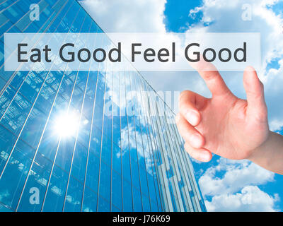 Eat Good Feel Good - Hand pressing a button on blurred background ...