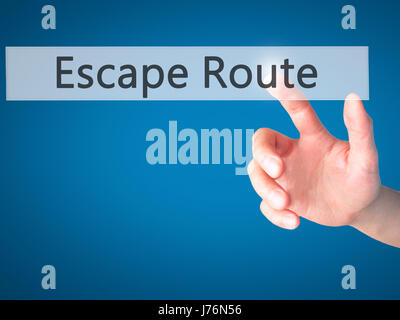 Escape Route - Hand pressing a button on blurred background concept ...