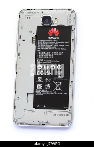 Mobile phone company Huawei on background of flag and USA dollars. The ...