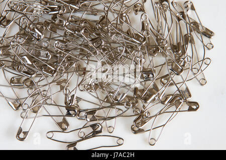 Pile of metal safety pins as background Stock Photo - Alamy