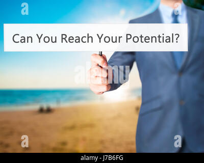 Can You Reach Your Potential ? - Business man showing sign. Business ...