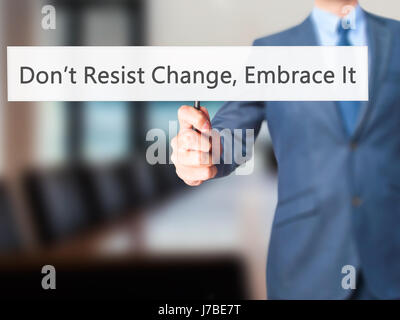 Don't Resist Change, Embrace It! - Businessman hand pressing button on ...