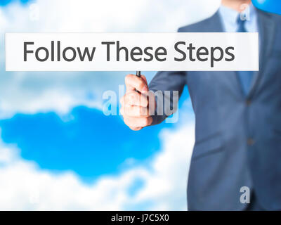 Follow These Steps - Businessman hand holding sign. Business ...