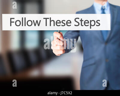 Follow These Steps - Businessman hand holding sign. Business ...