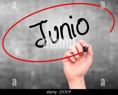 Man Hand writing Junio (June in Spanish) with black marker on visual ...