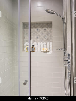 Tiled shower recess in bathroom with freestanding bath in UK home Stock ...