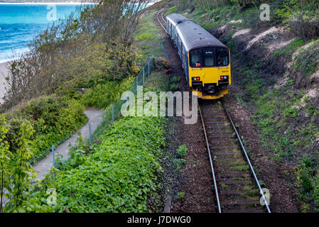 A St Ives to St Erth branch line train leaving Carbis Bay station Stock ...