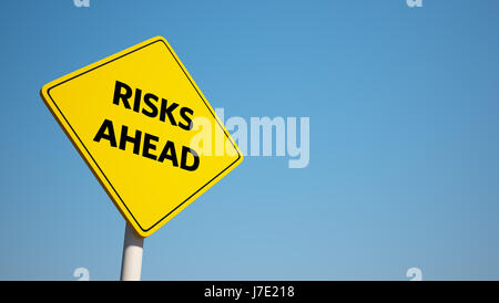 Risks Sign isolated on clean blue sky Stock Photo - Alamy
