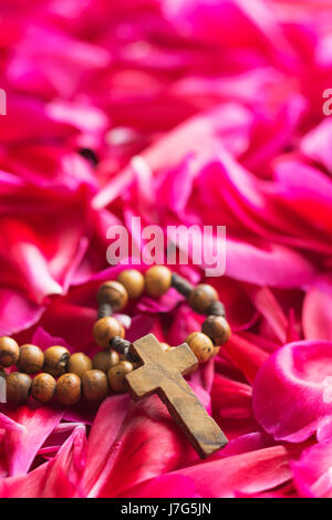 Rosary beads on flower background. Pray concept. Top view Stock Photo ...