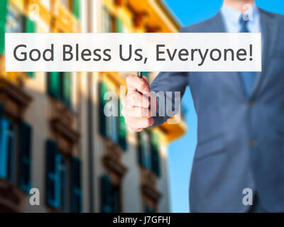 God Bless Us, Everyone! Sign on white paper. Man Hand Holding Paper ...