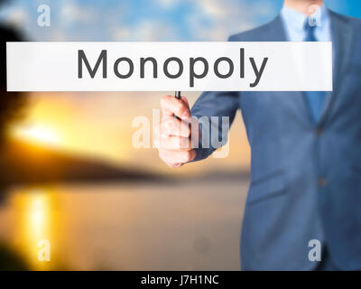 Monopoly - Businessman hand holding sign. Business, technology ...