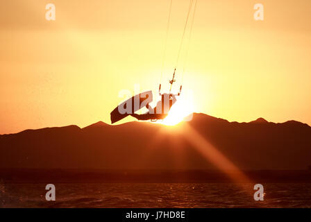 Silhouette of a fly board rider at sea and Parasailing in blue sky ...