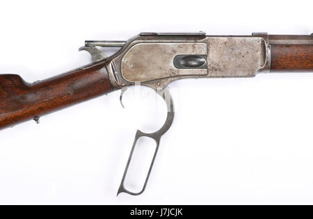 Old west lever-action rifle and ammunition with silver dollars coins on ...