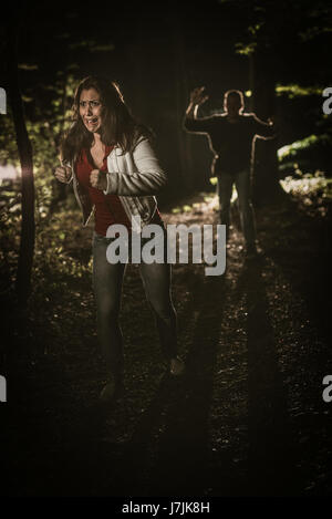 Scared young woman running away looking over shoulder Stock Photo - Alamy