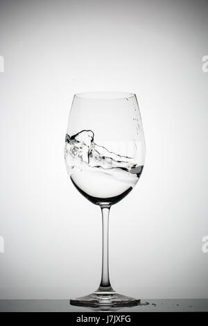 wineglass with splashing water, freeze liquid motion Stock Photo - Alamy