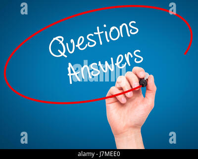 Hand writing Any Questions with blue marker on transparent wipe board ...