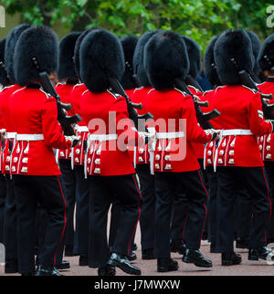 Soldiers in classic red coats march along The Mall in London, England ...
