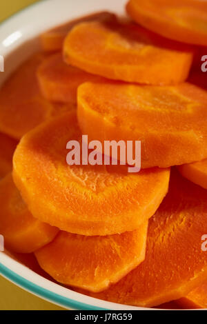 poached sliced carrots, sometimes called carrot coins Stock Photo - Alamy