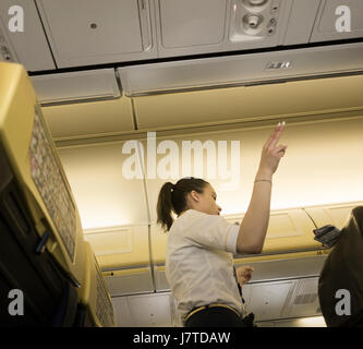 Air hostess on Ryanair flight doing safelty demonstration as passengers ...