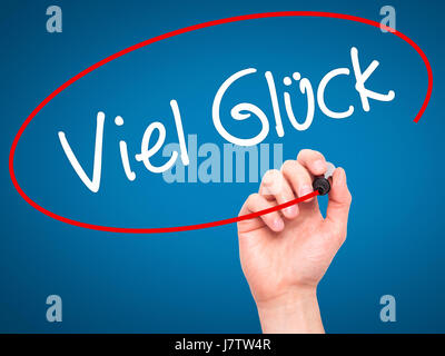 Man Hand writing Viel Gluck (Good Luck in German) with black marker on ...