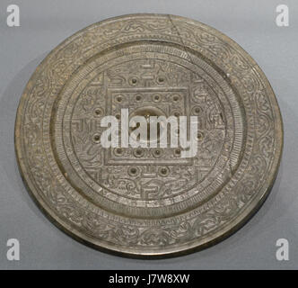 This bronze mirror from the Han Dynasty features intricate designs and ...