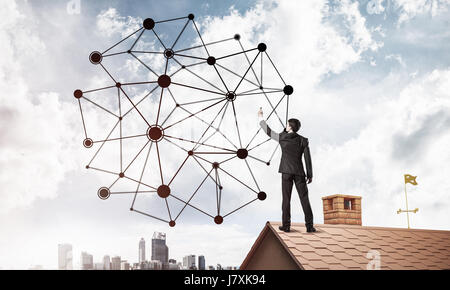 Businessman on house roof presenting networking and connection c Stock ...