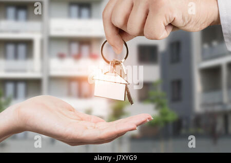 Keys and house chrome pendant on home project Stock Photo - Alamy