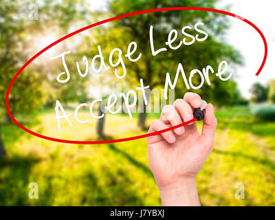 Man Hand writing Judge Less Accept More with black marker on visual ...