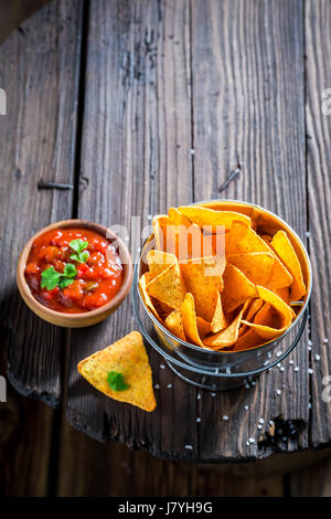 Golden nachos with salt and spicy red sauce Stock Photo - Alamy