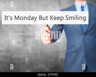 It's Monday But Keep Smiling - Businessman hand holding sign. Business ...