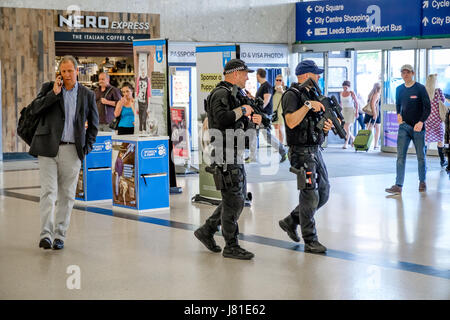 A Tactical Firearms officer from the City of London Police (left) and ...
