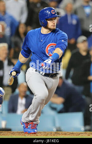 Chicago Cubs' Ian Happ, right, high fives first base coach Jose Javier ...