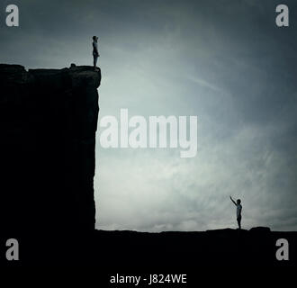 Man standing on the edge of a rock on a sunny day Stock Photo - Alamy