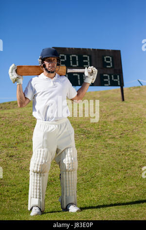 Cricket player, standing holding bat on shoulder Stock Photo - Alamy