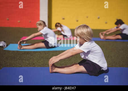 Schoolkids performing stretching exercise Stock Photo - Alamy