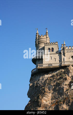 A small castle on a high rock with dense forests and views of the sea ...