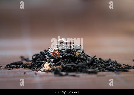 Heap of Dry tea leaves spread on light brown color background Stock ...